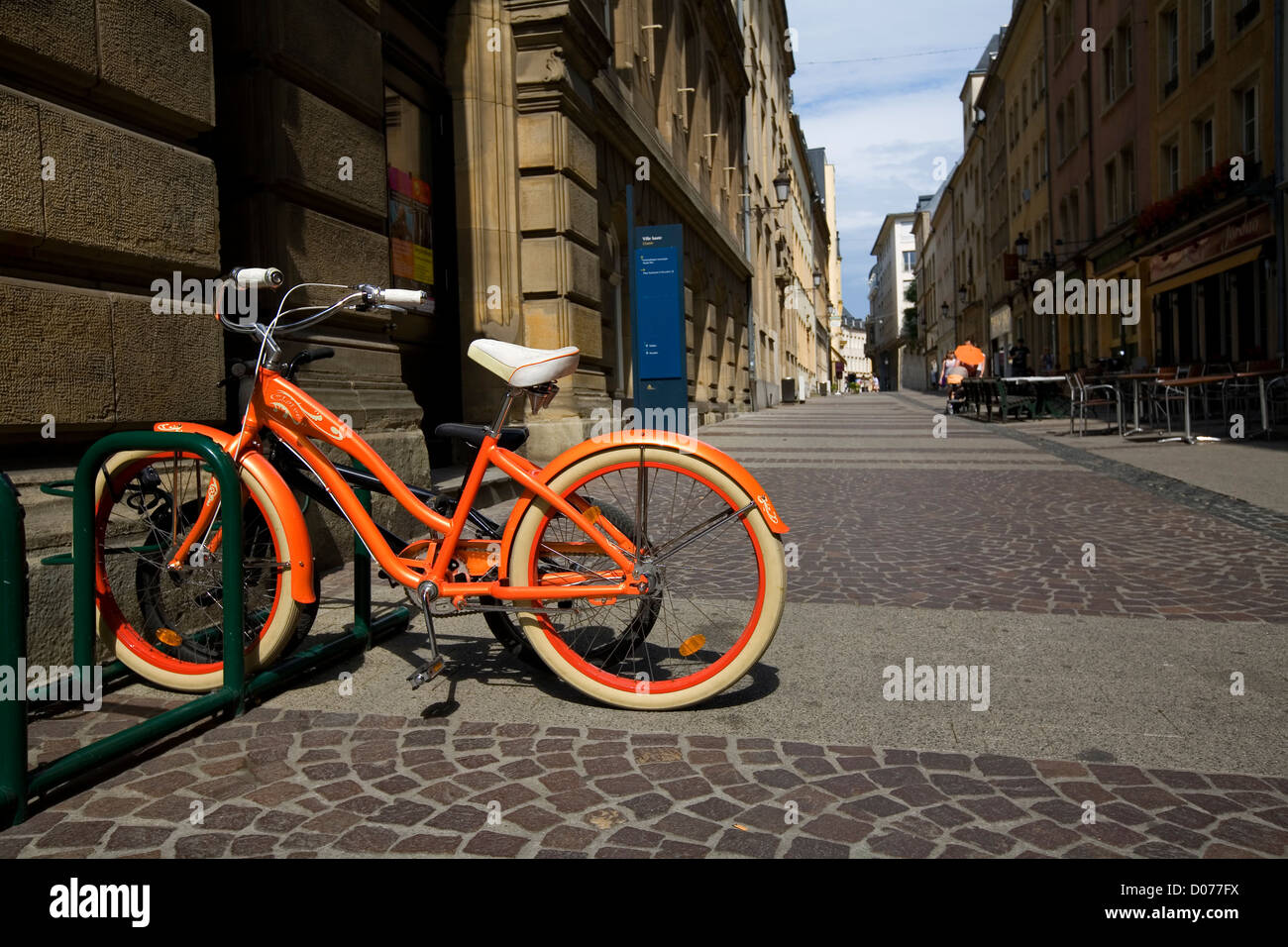 Orange bike in european city Stock Photo - Alamy