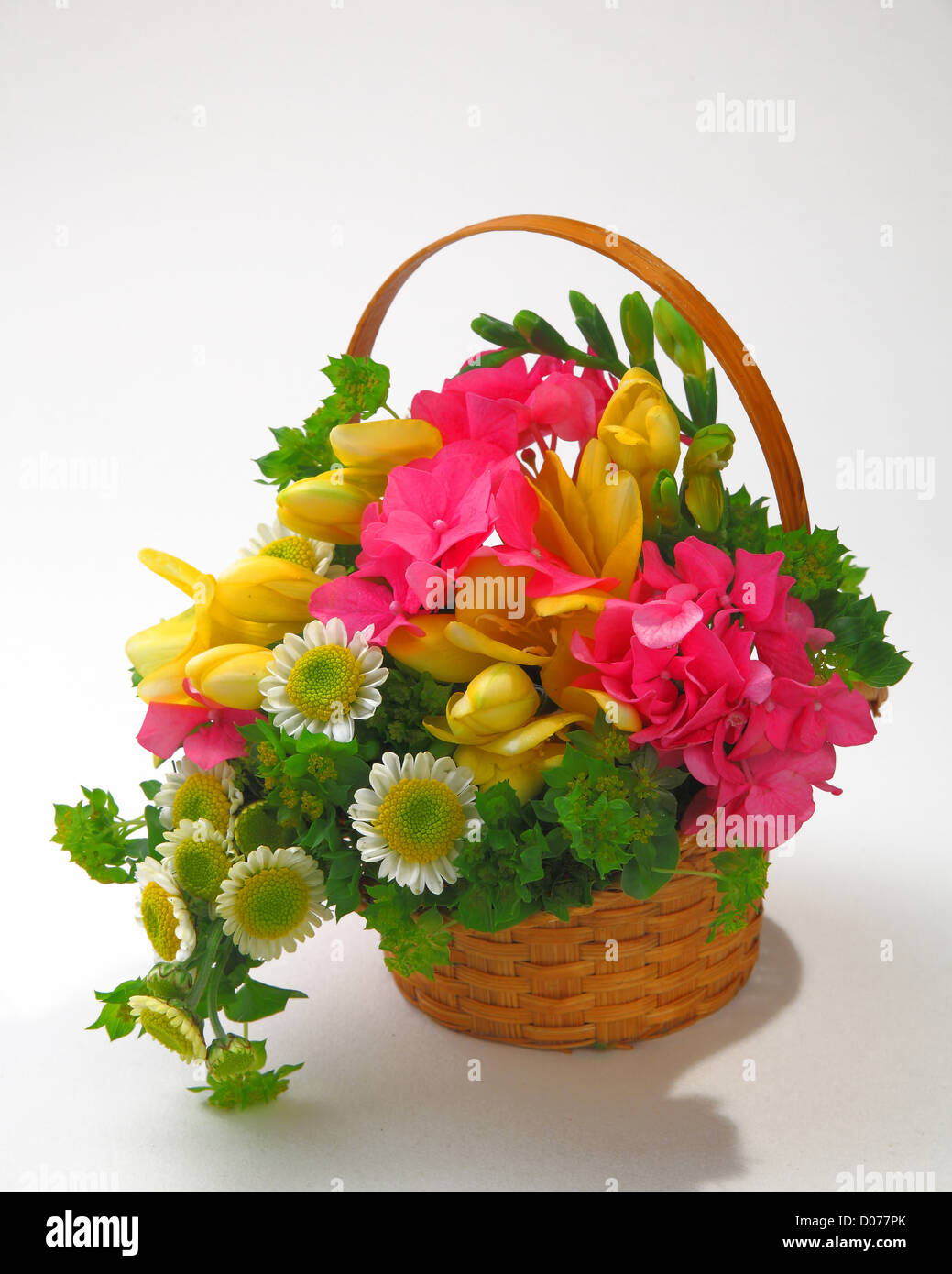bunch of the flowers arranged in the basket isolated in gray Stock ...