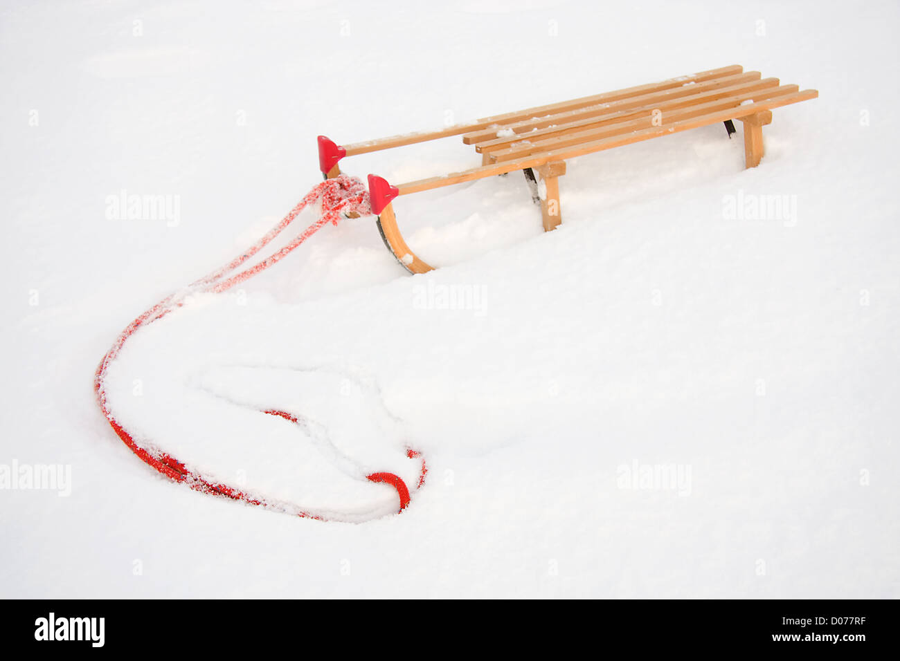 empty wooden sledge lying in the snow Stock Photo - Alamy