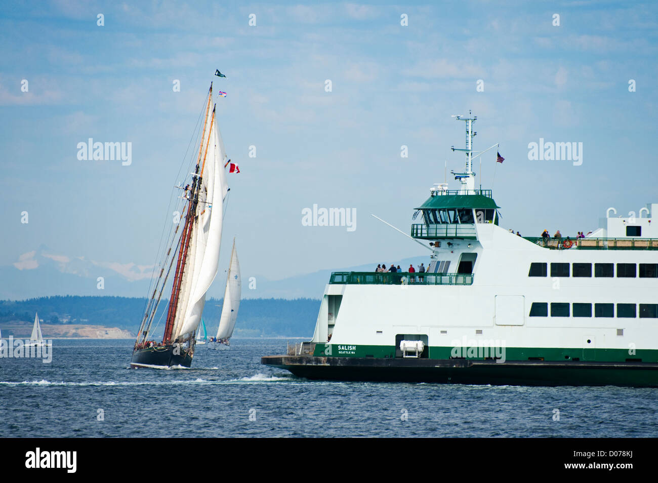 A Washington State Ferry passes a tall ship en route to Kingston ...
