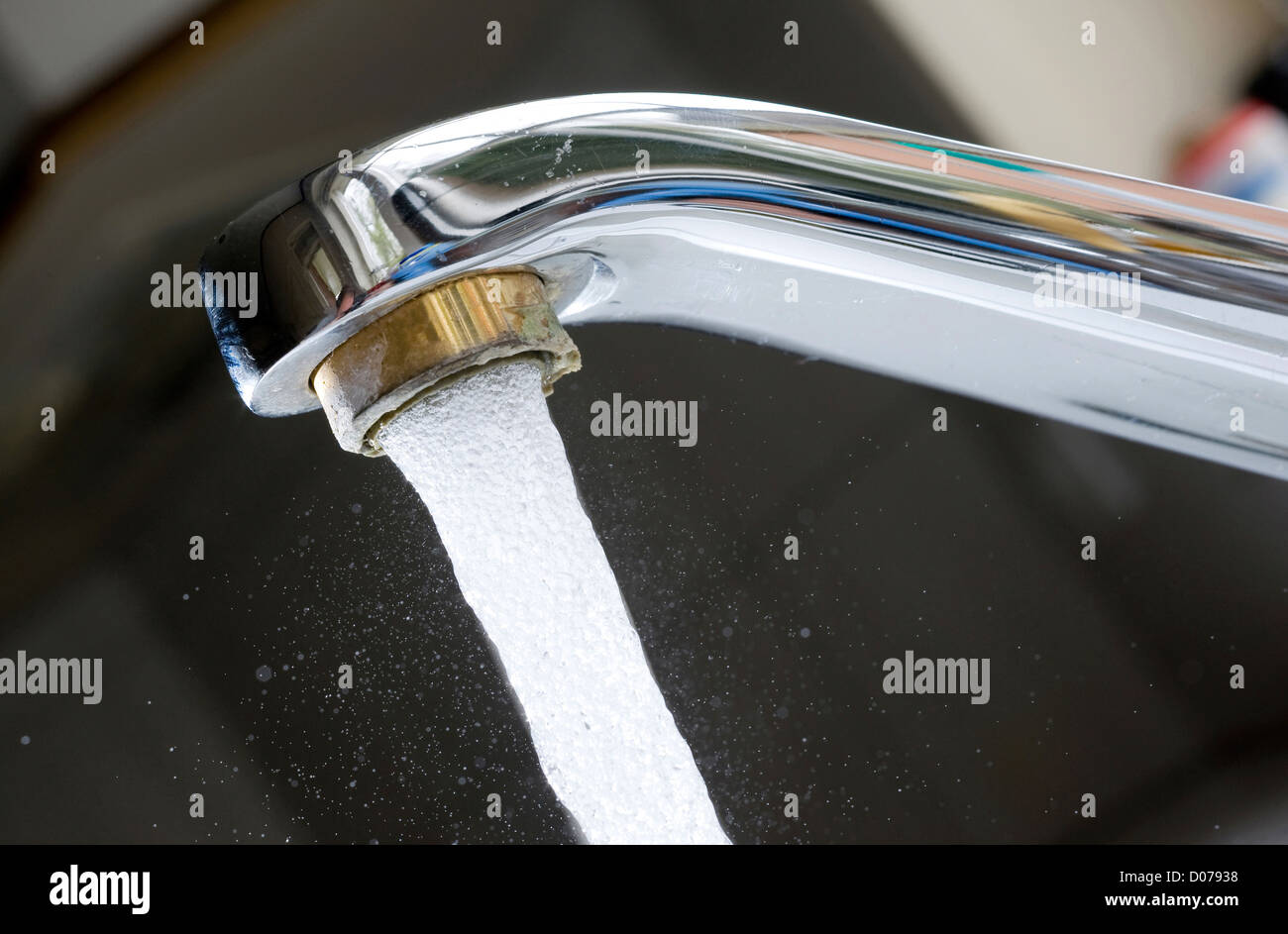 Water is floating from a tap in the kitchen Stock Photo - Alamy