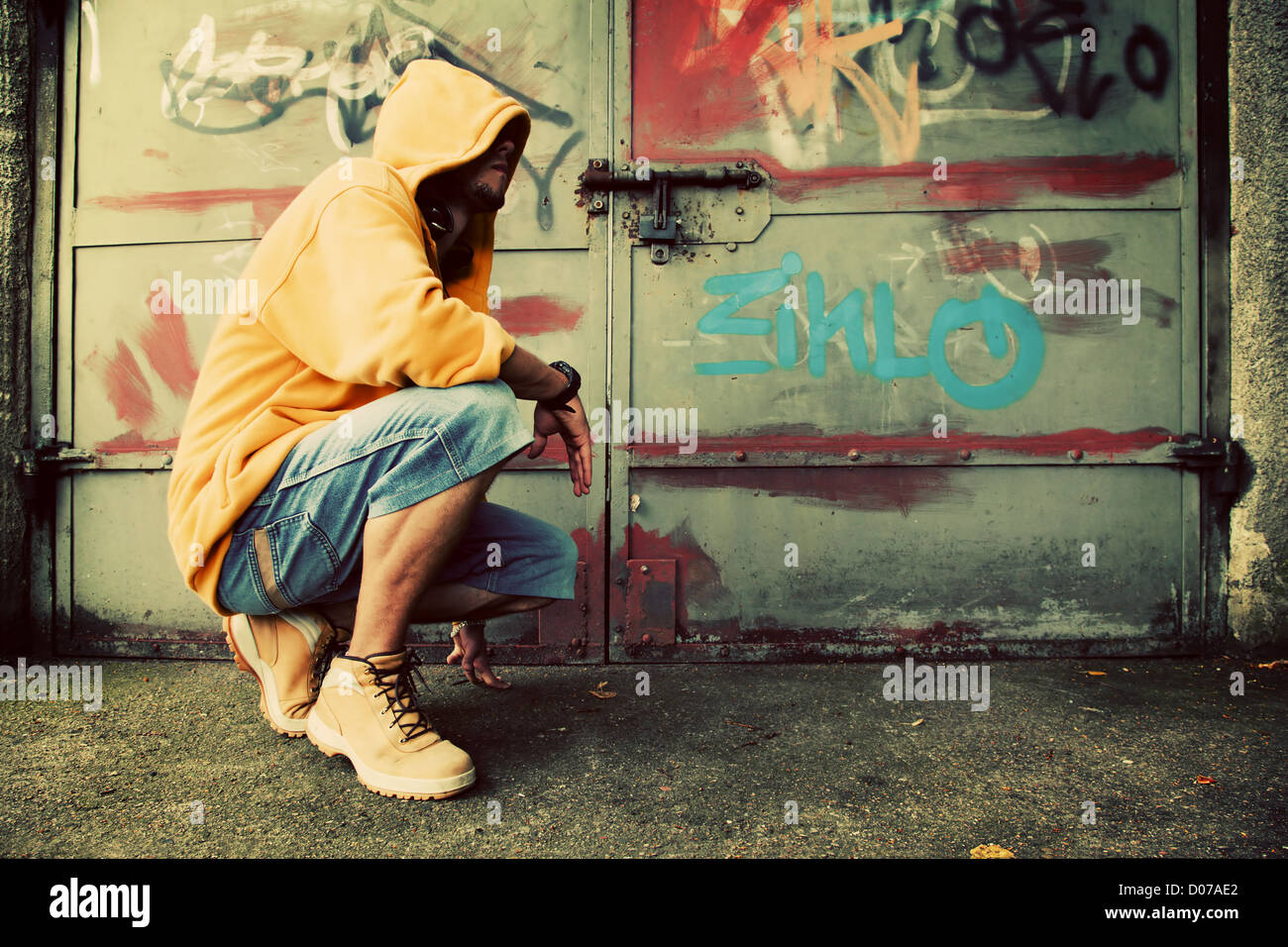 Young man portrait in hooded sweatshirt / jumper on grunge graffiti ...