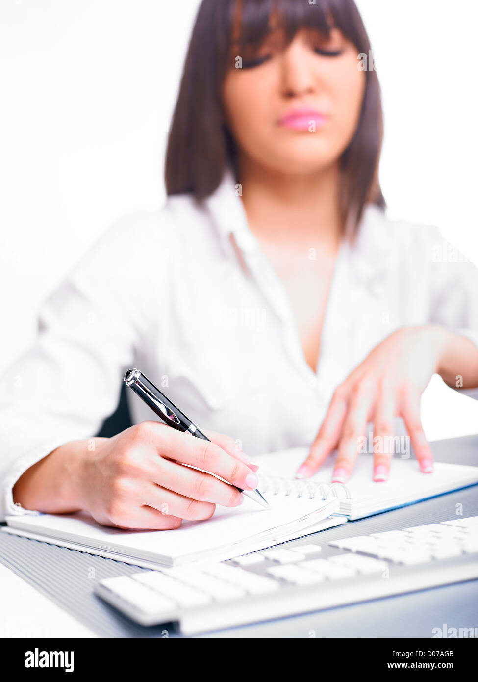 Happy Business Woman Writing in notepad Stock Photo - Alamy