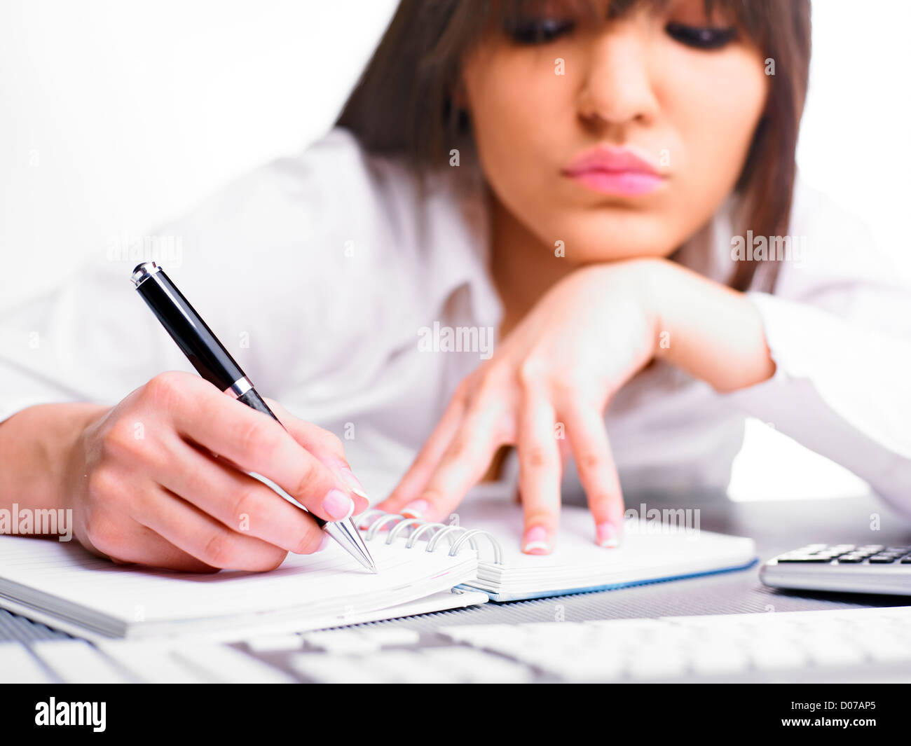 Happy Business Woman Writing in notepad Stock Photo - Alamy