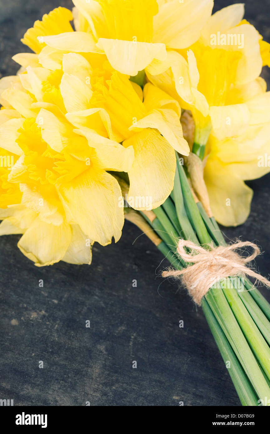a bunch of daffodils on the wooden board Stock Photo - Alamy
