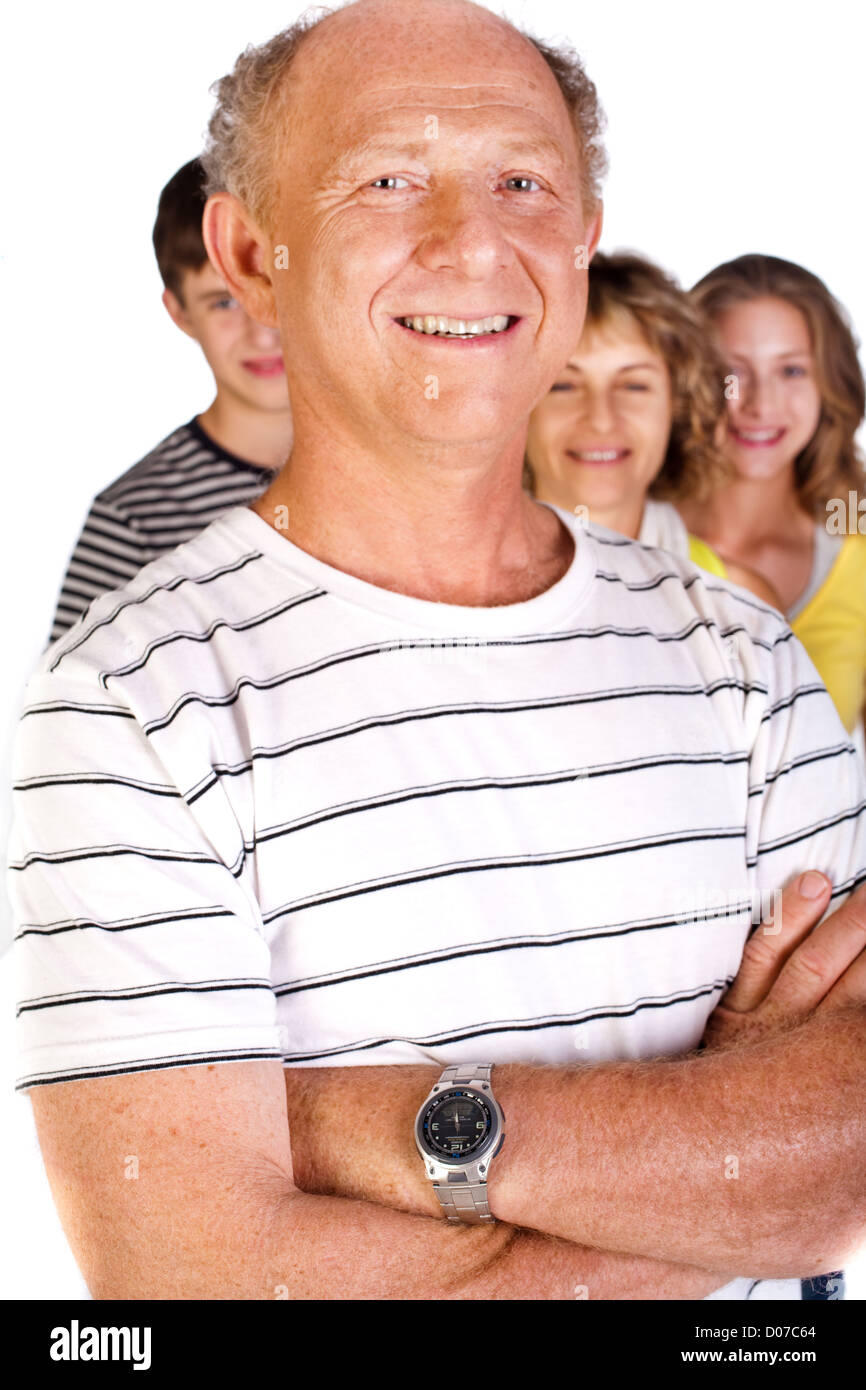 Happy family with old man in focus, arms folded isolated against the ...