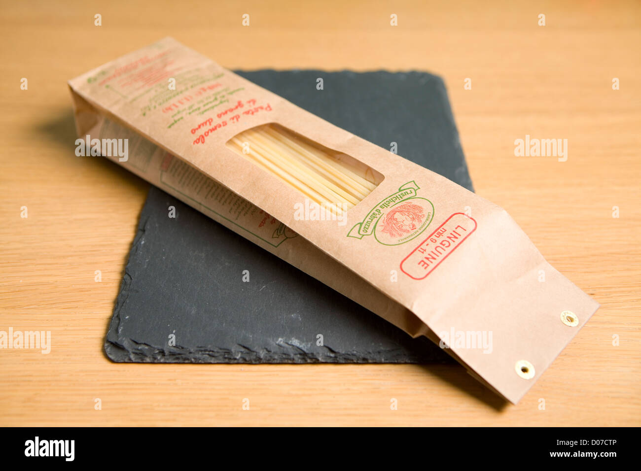 A packet of dry linguine on a slate plate Stock Photo - Alamy
