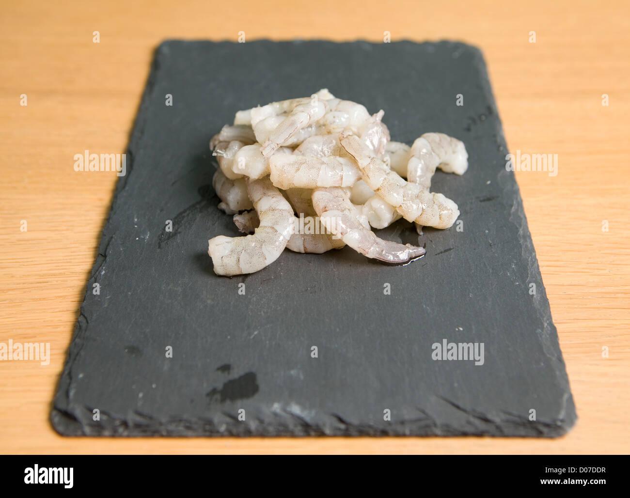 Raw king prawns presented on a slate plate Stock Photo - Alamy