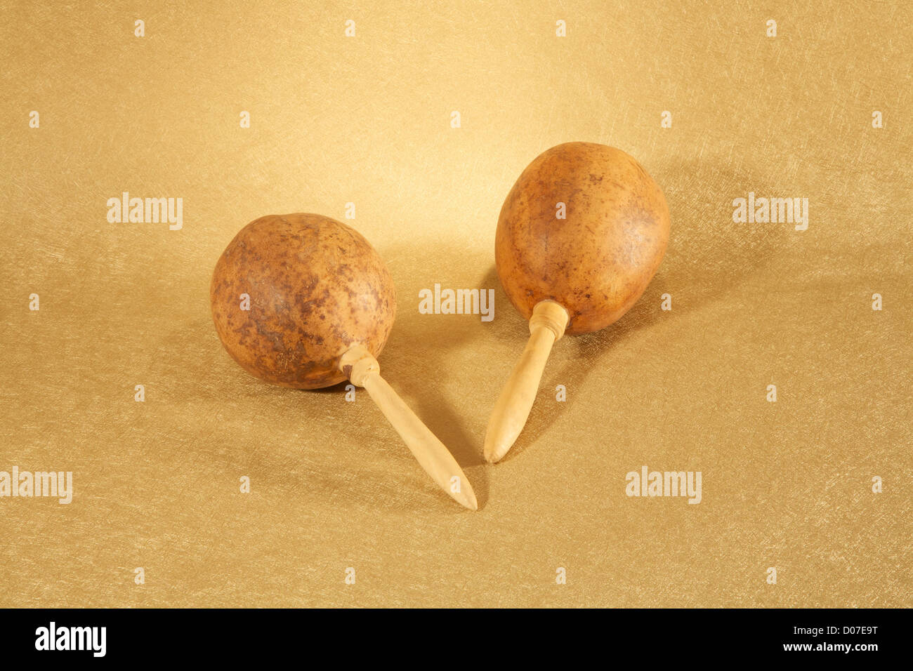 two maracas on golden textured paper at still life Stock Photo - Alamy