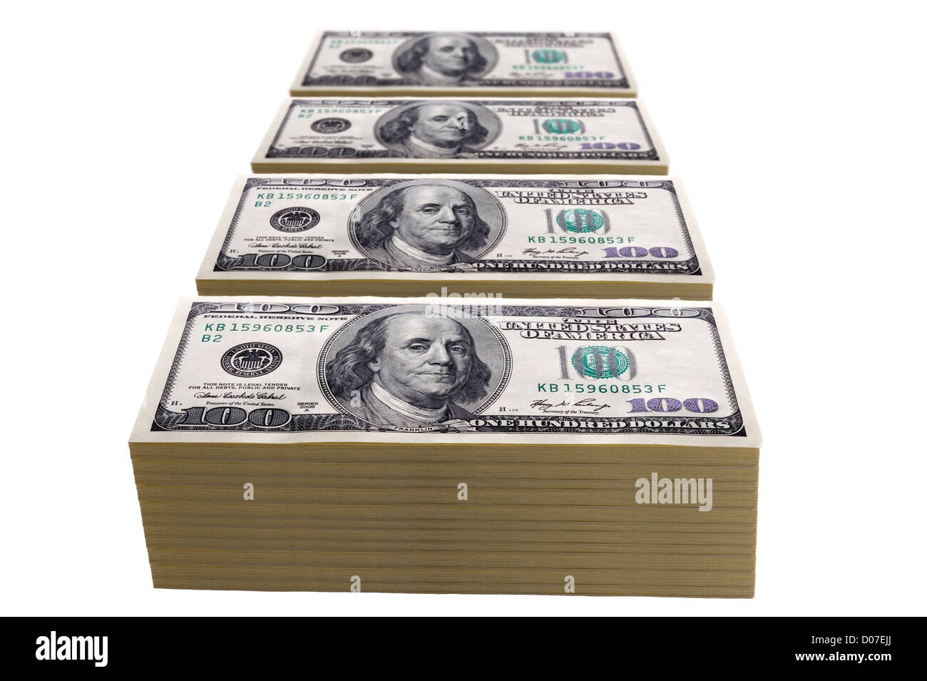 one hundred dollar bills in stacks in a line isolated on white ...