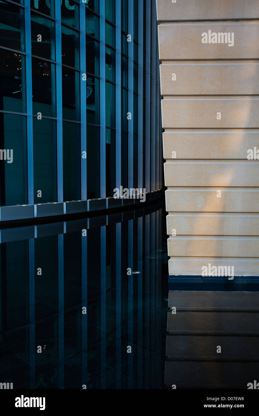 Horizontal and vertical lines of a building are reflected in the water ...