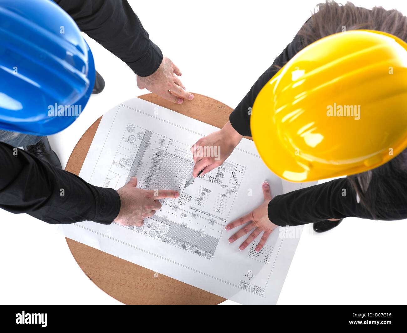 Two architects with hard hats and plan on meeting in office Stock Photo ...