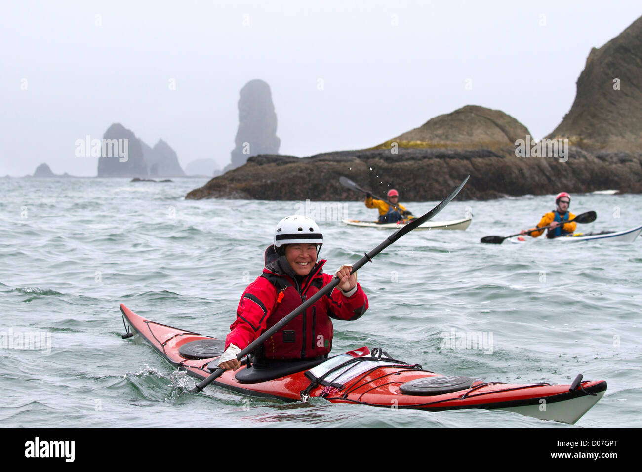 USA, Washington State, Olympic National Park. Woman sea kayaker and ...