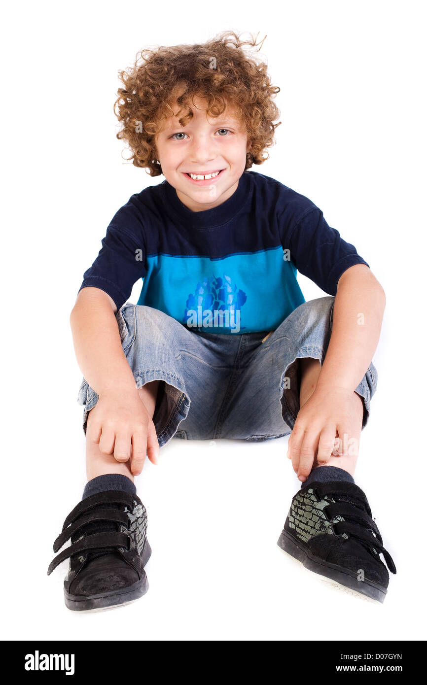 Adorable young kid sitting on floor isolated on white Stock Photo - Alamy