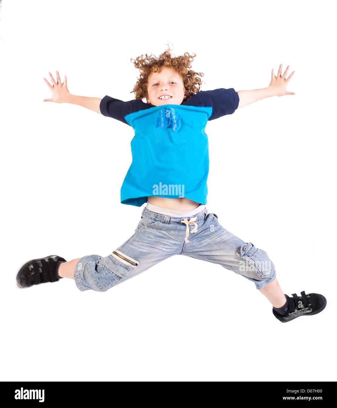Attractive young kid jumping high, indoors Stock Photo - Alamy