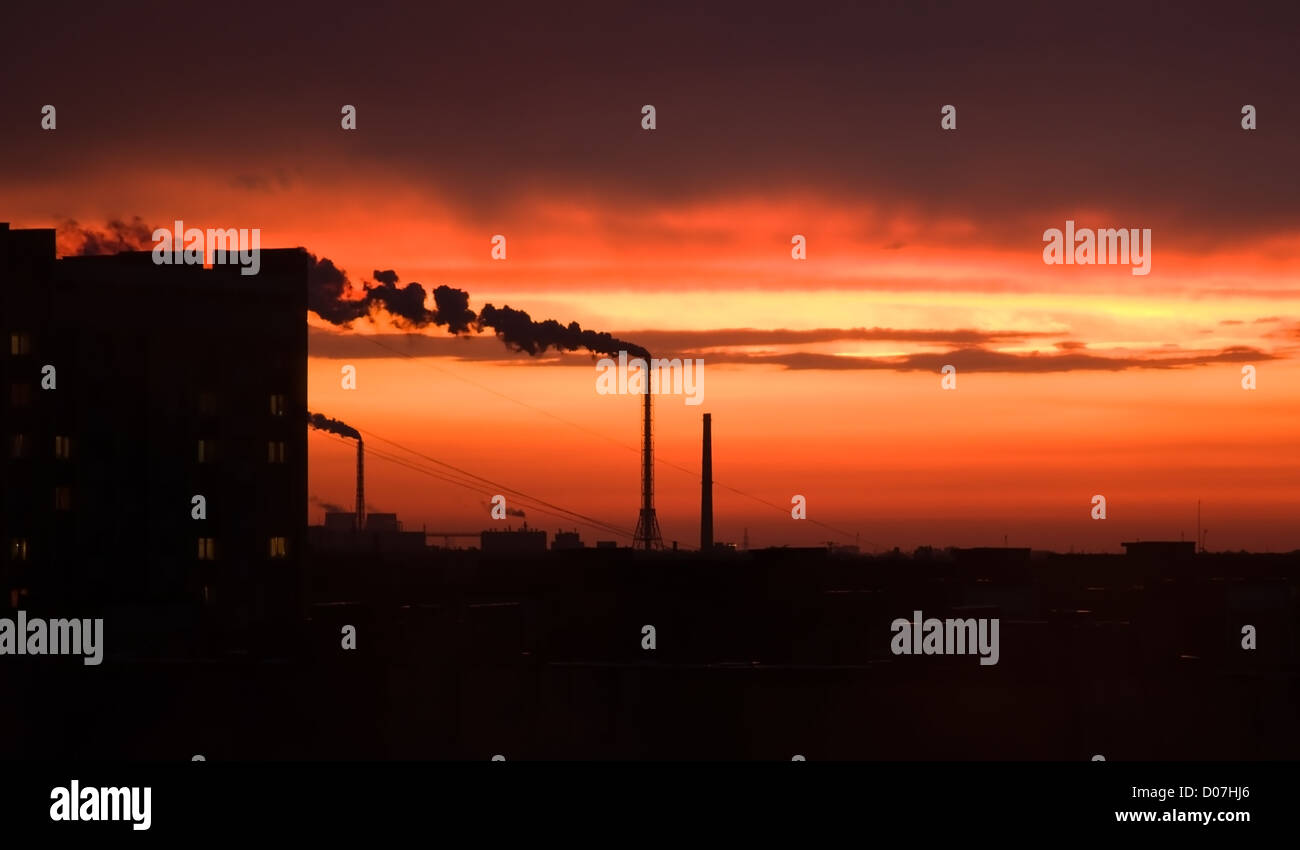 photograph of industrial buildings at sunset sky Stock Photo - Alamy