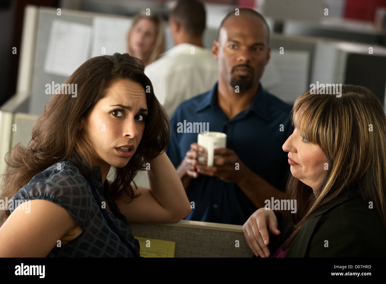 Worried woman office worker chats with friends at her cubicle Stock ...