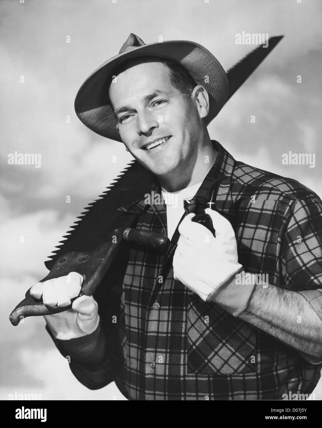 Portrait of lumberjack carrying saw Stock Photo - Alamy