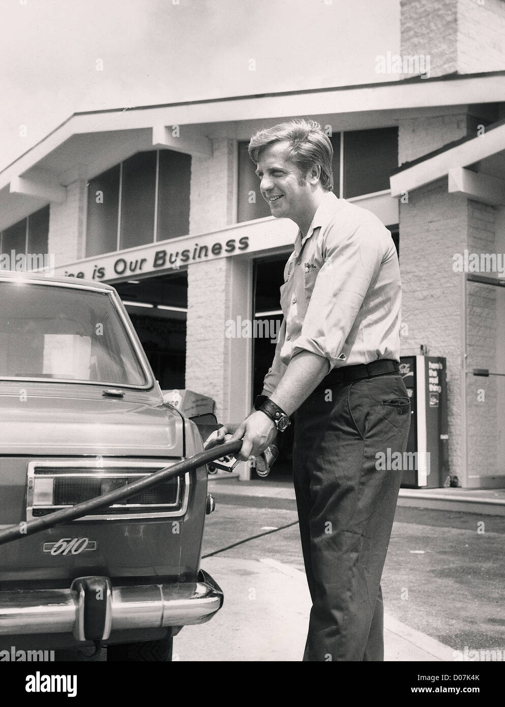 Worker pumping gas at gas station Stock Photo - Alamy
