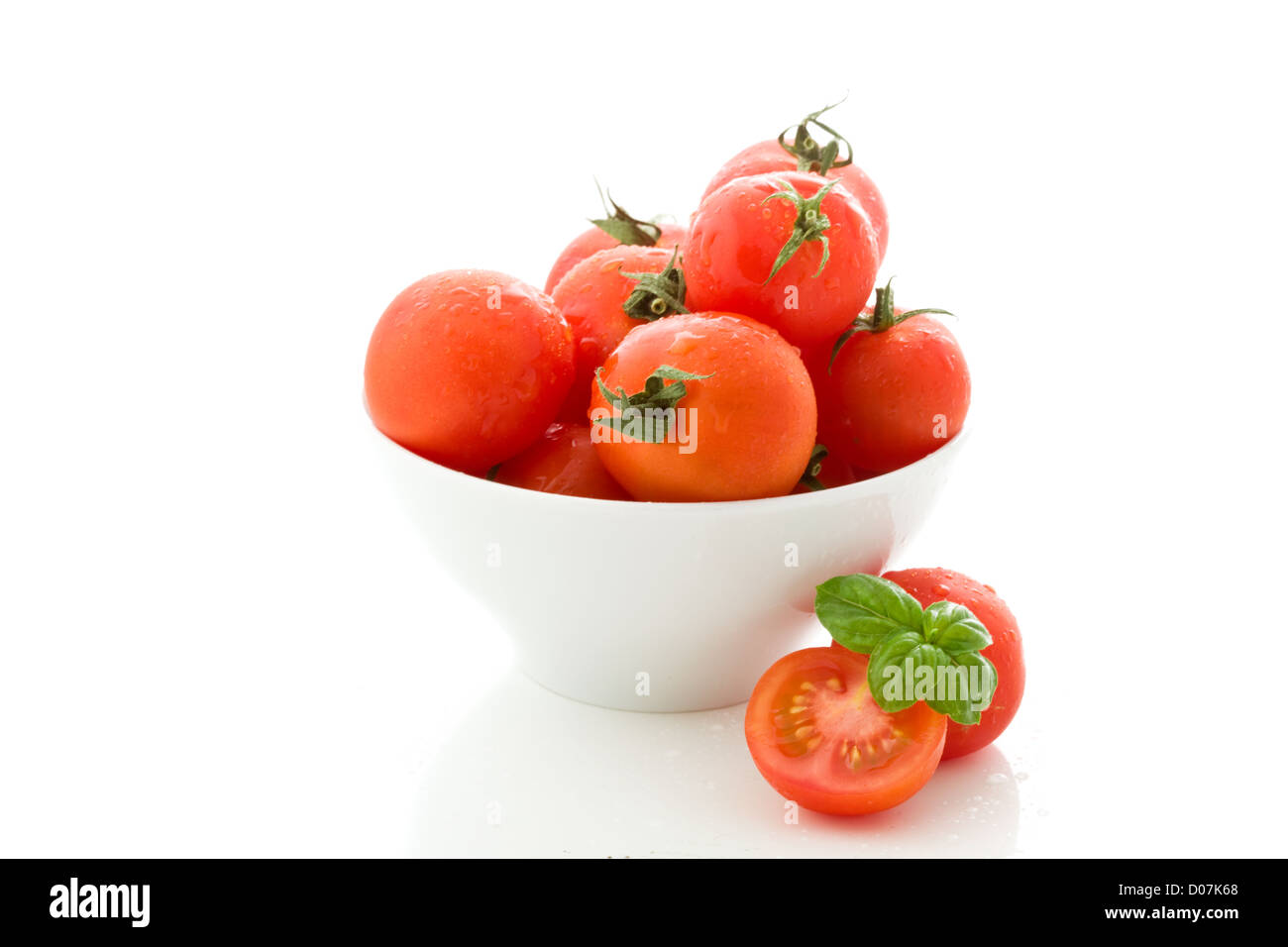 photo of delicious tomatoes inside a bowl on white isolated background ...