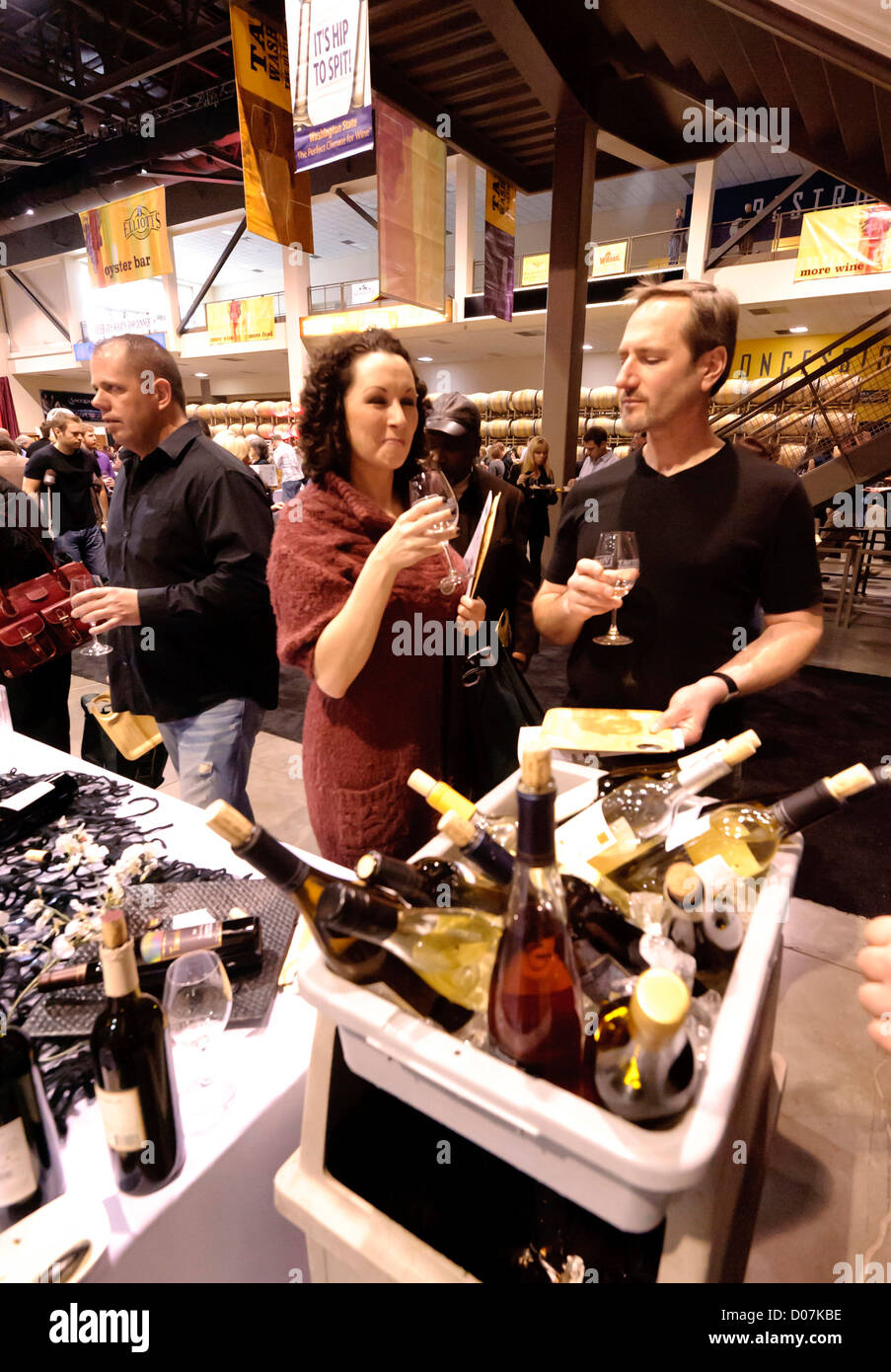USA, Washington, Seattle. Two wine fans enjoy Taste Washington 2011 ...
