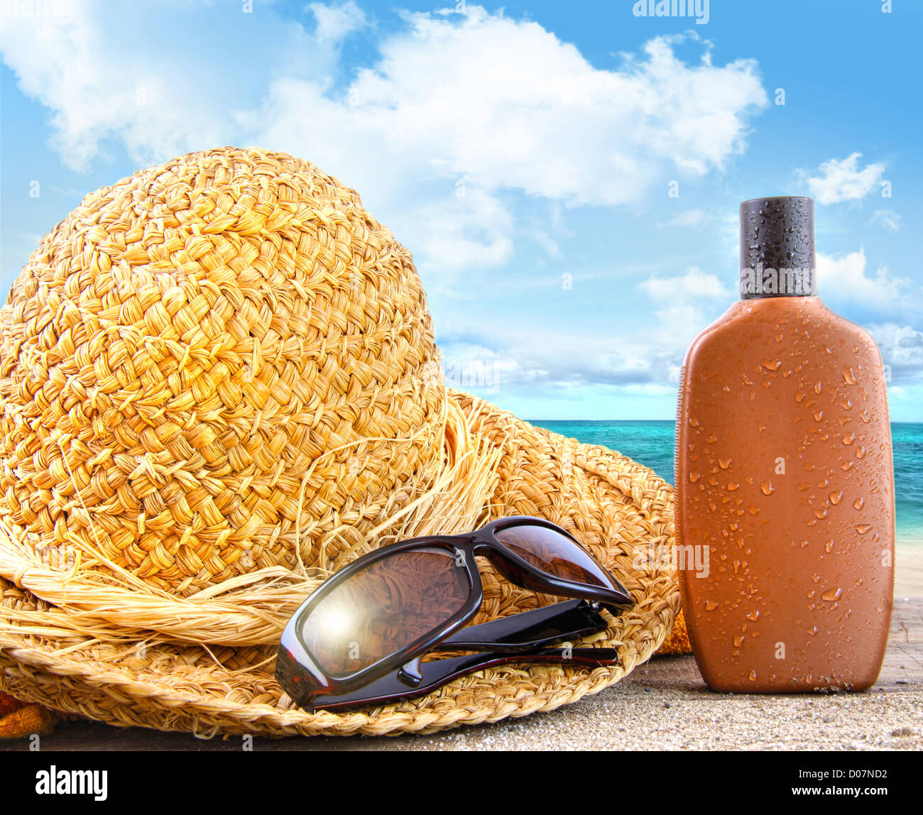 Beach items and suntan lotion on table at the beach Stock Photo - Alamy