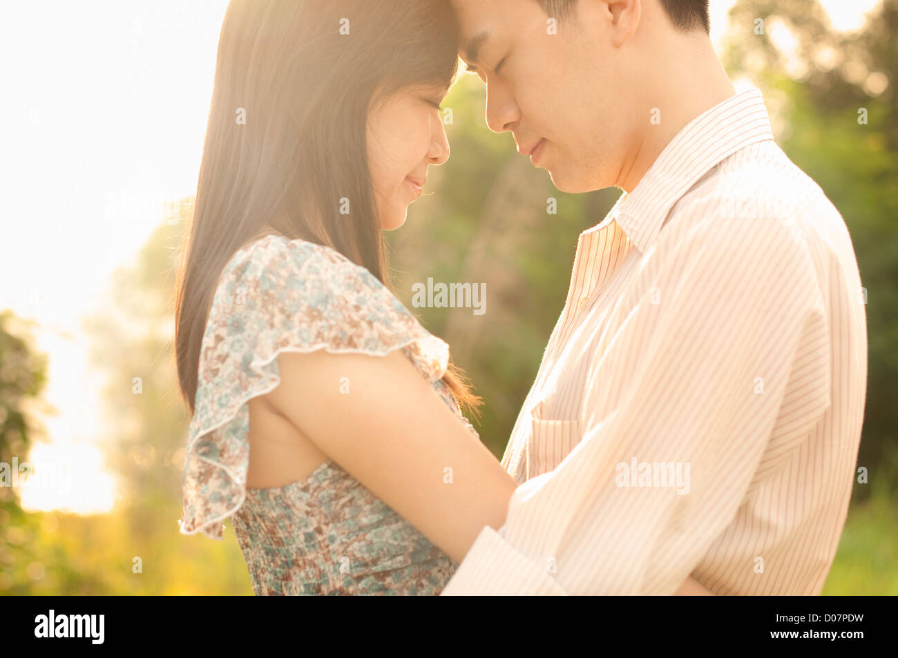 Young couple in love, face to face in sunset Stock Photo - Alamy