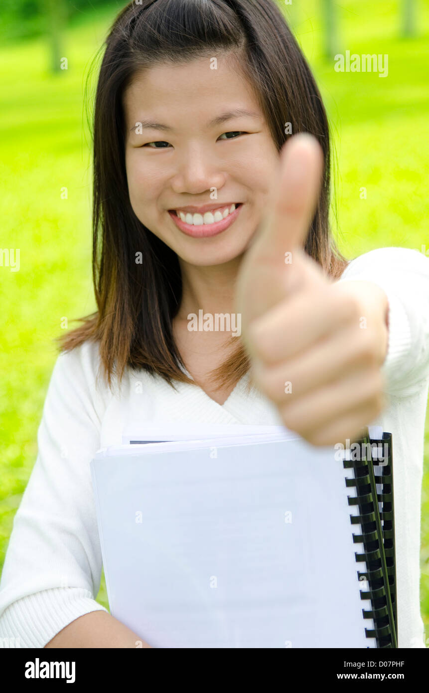 Female student thumbs up with great smile Stock Photo - Alamy