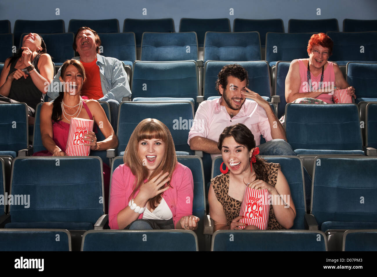 Group of seven people laughing out loud in a theater Stock Photo - Alamy