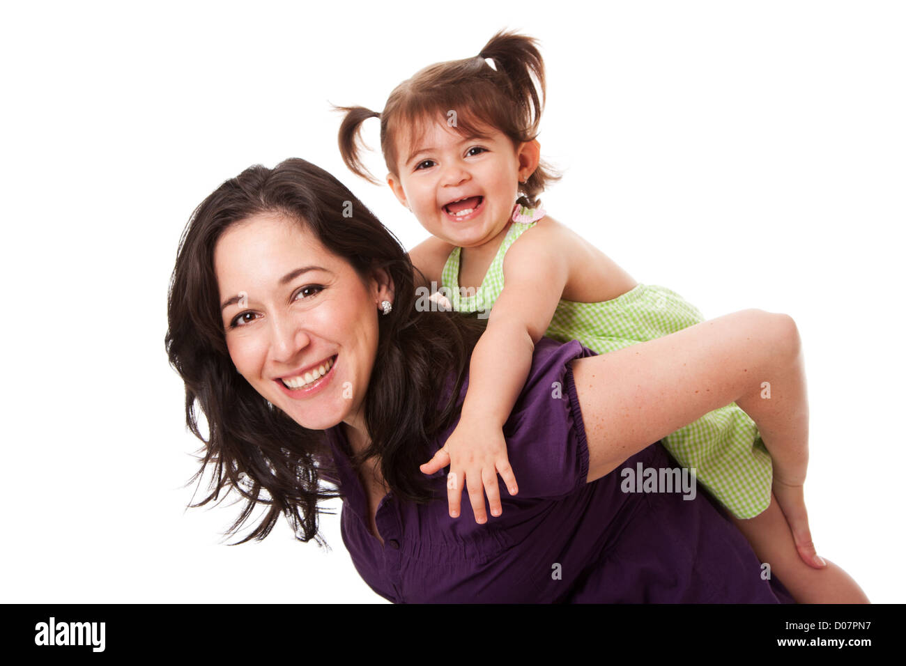 Happy laughing toddler girl playing with mom doing a fun piggyback ride ...