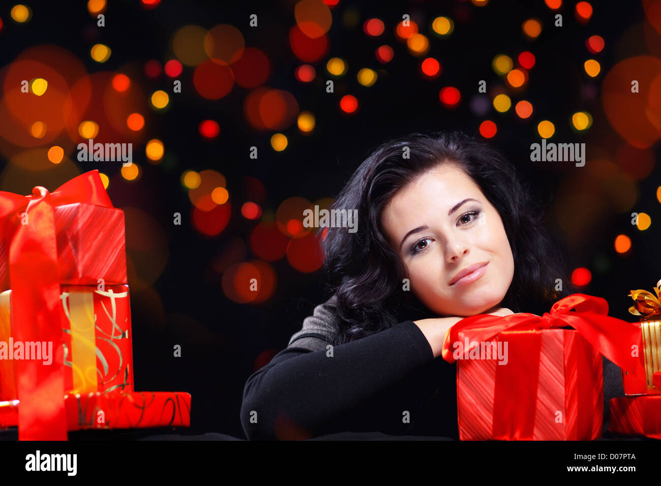 Cute woman with presents at night Stock Photo - Alamy