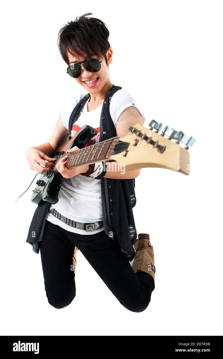 Punk Rockstar holding a guitar kneeling isolated in white Stock Photo ...