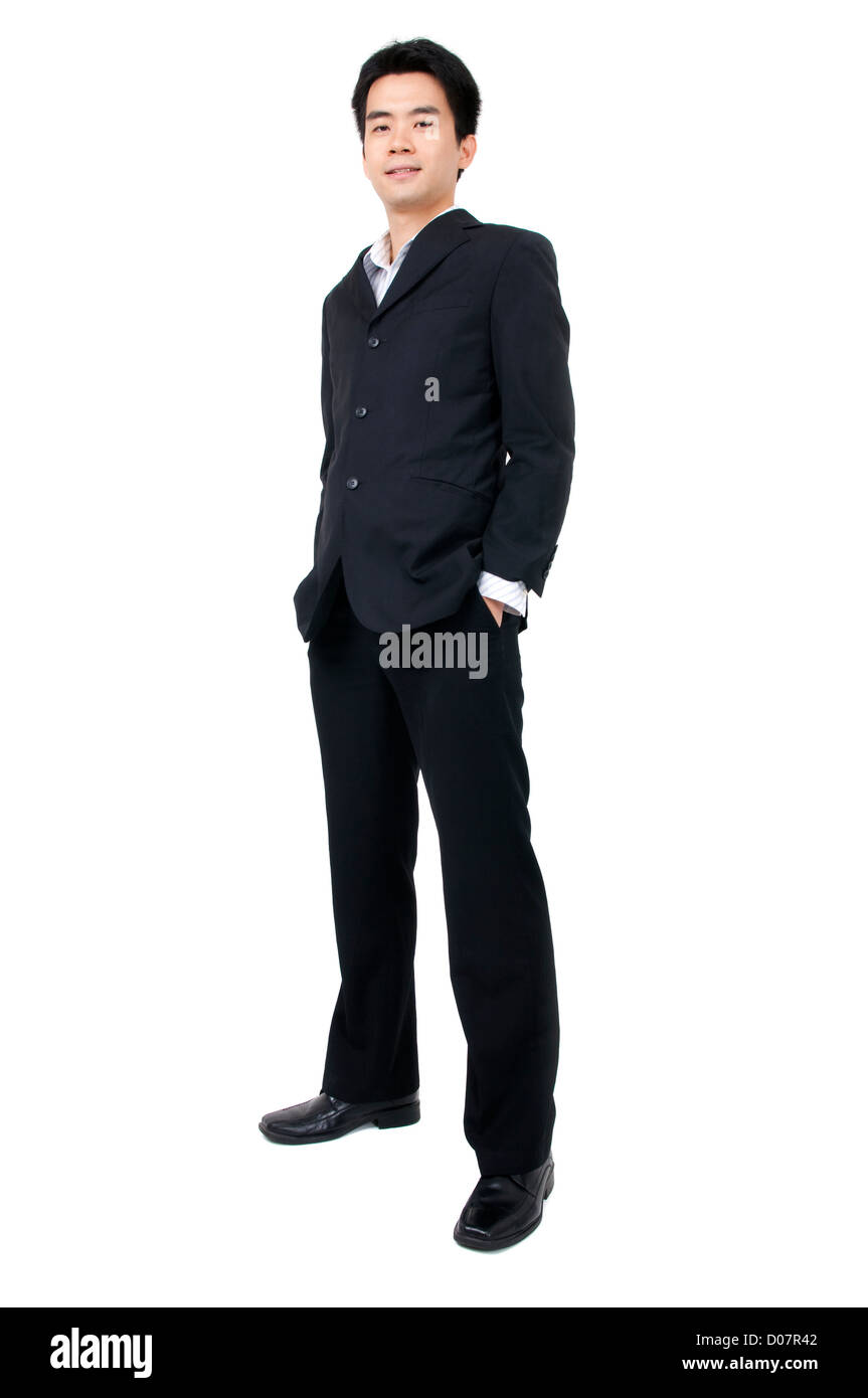 Full body of a smiling young Asian executive standing against isolated ...