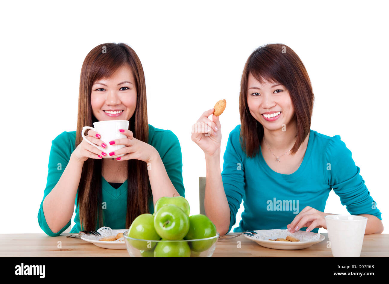 Two Asian women having tea break Stock Photo - Alamy