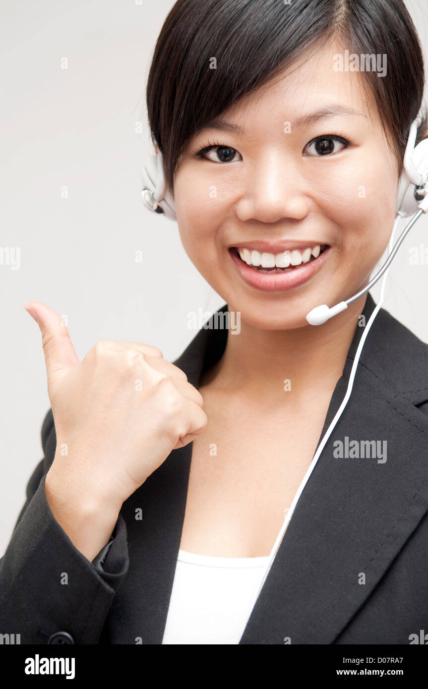 Thumb up Friendly Customer Representative with headset Stock Photo - Alamy