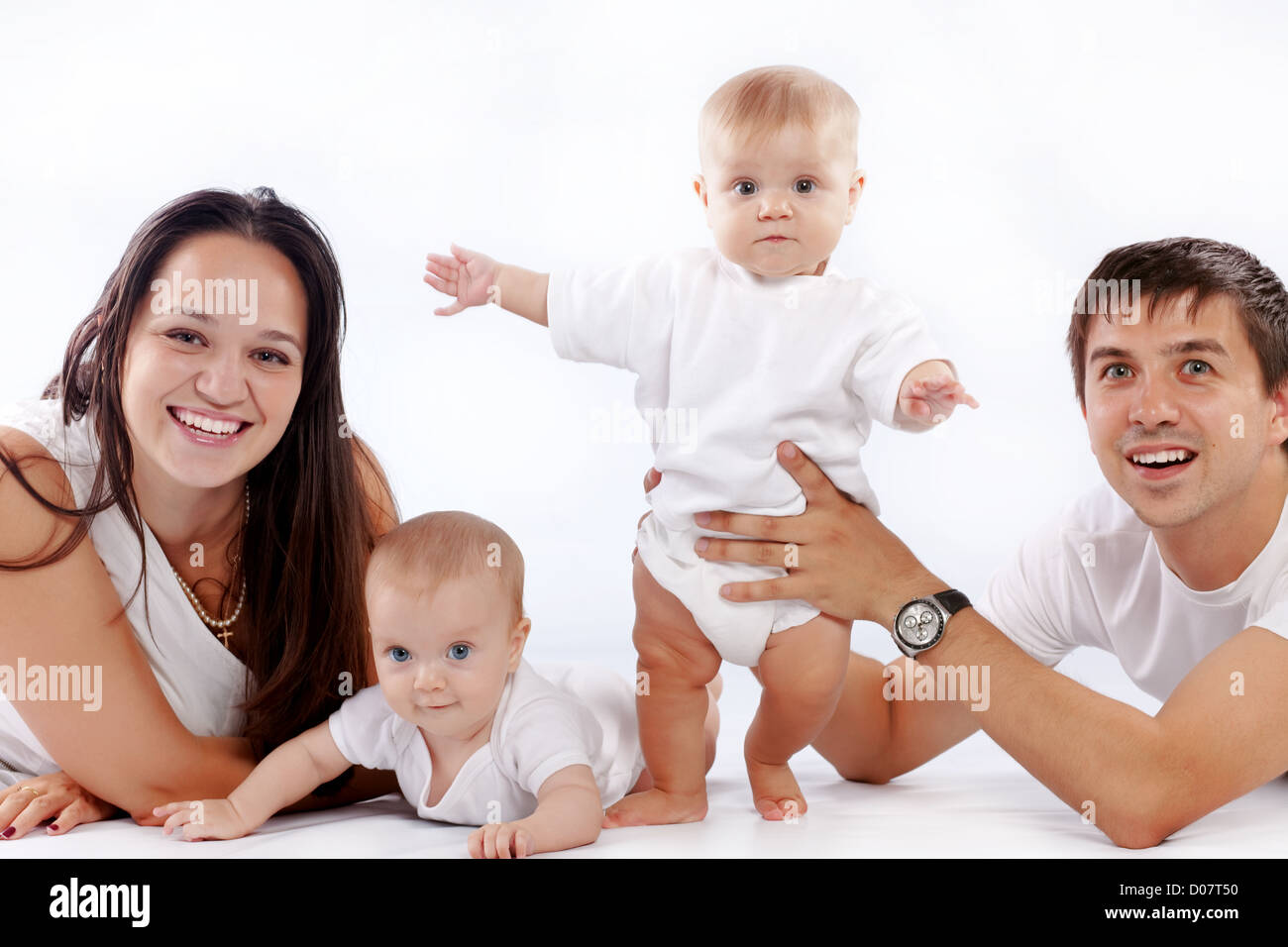 Studio portrait of happy young family with little children Stock Photo ...