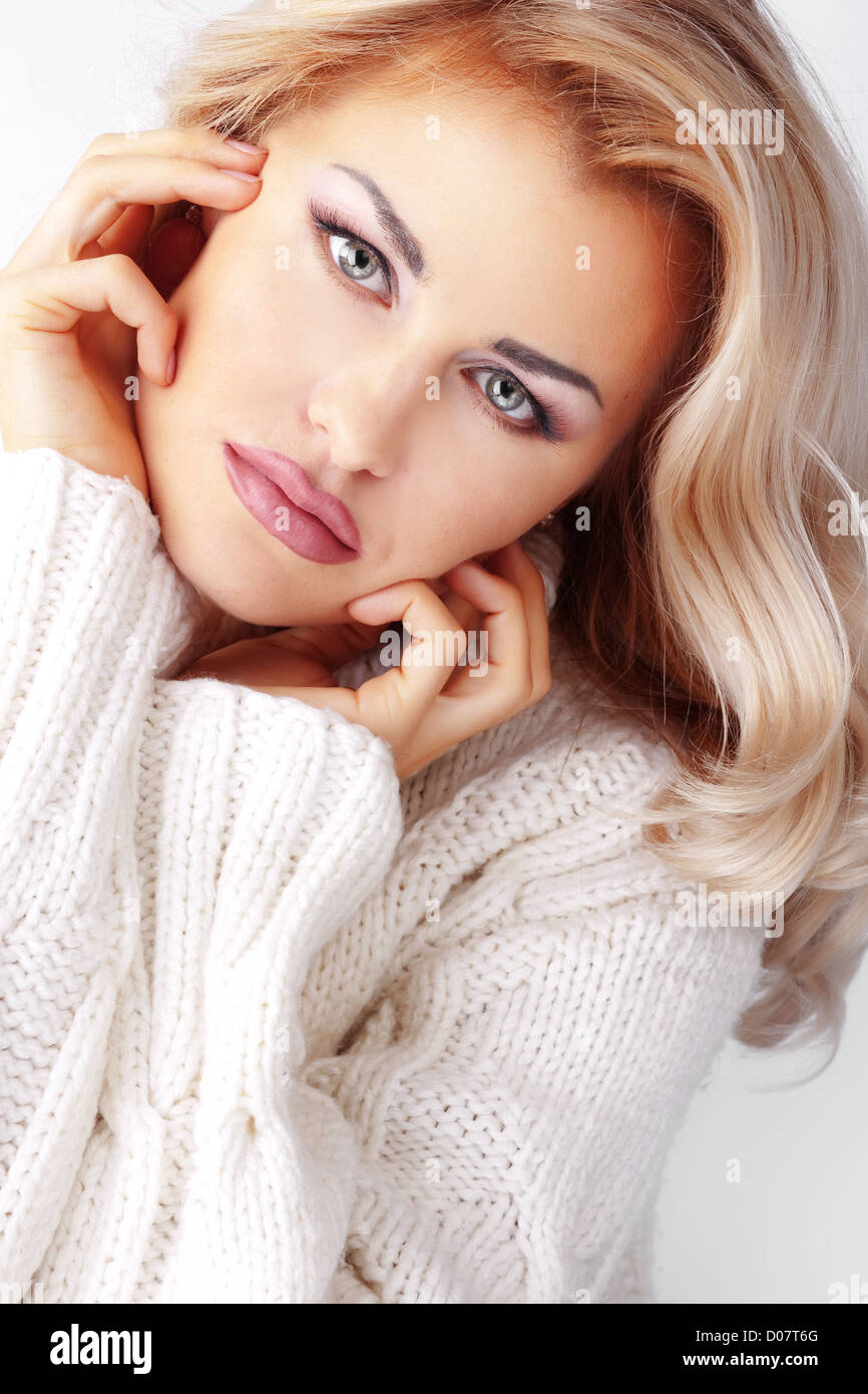 Portrait of pure beautiful woman wearing winter warm clothing over ...