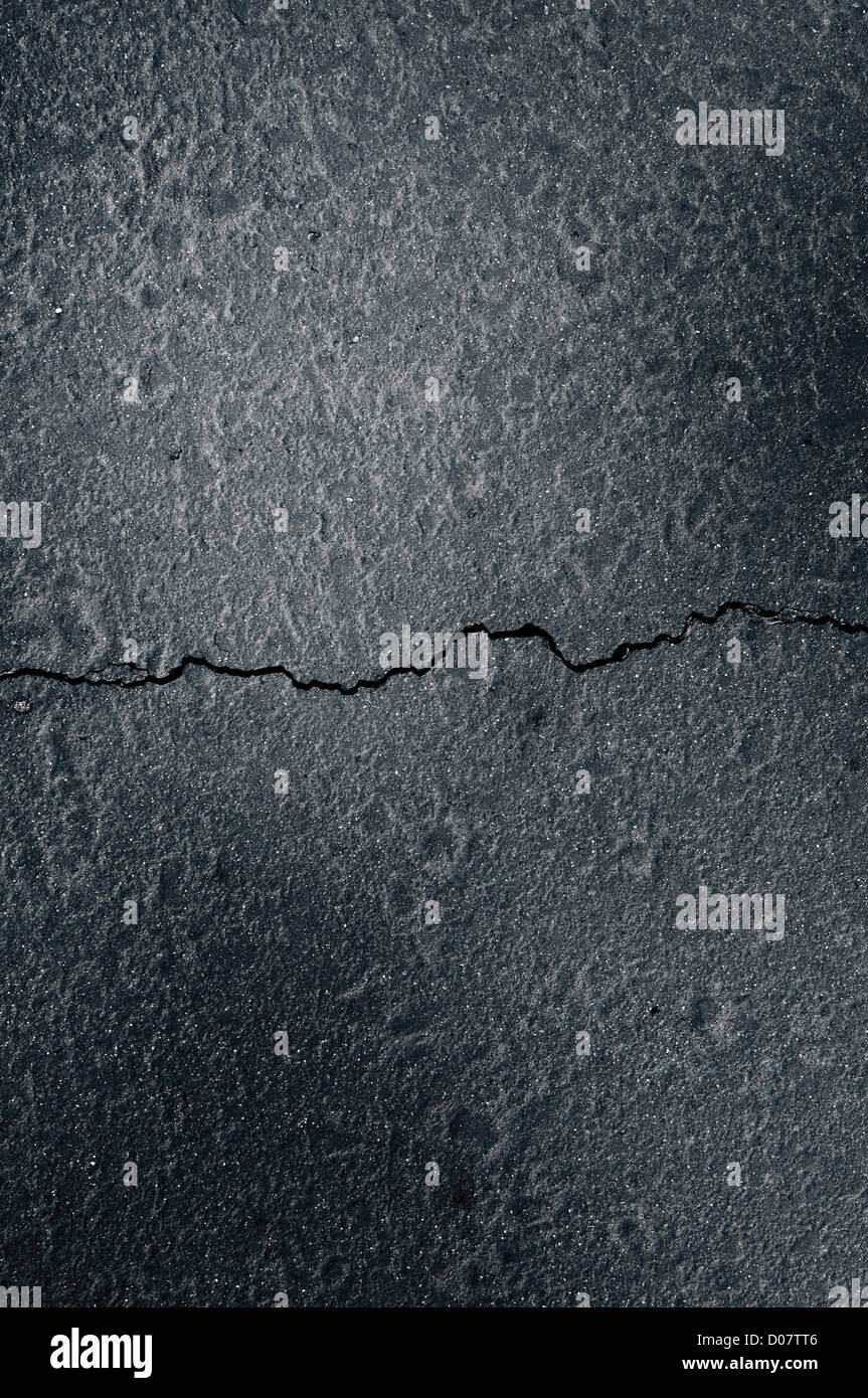 Cracked Black Concrete split in half Stock Photo - Alamy