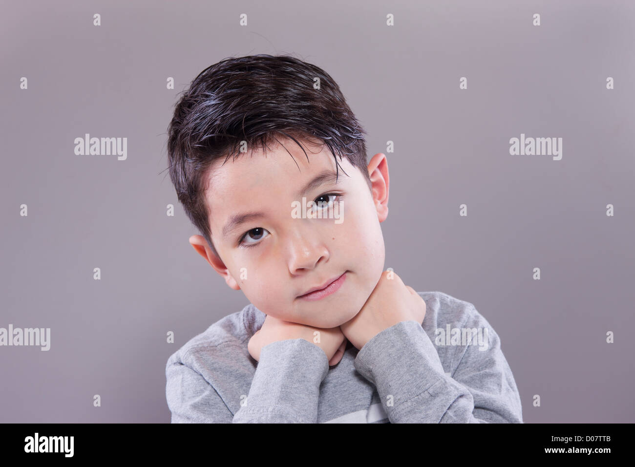 A mild expression of a young boy in a studio Stock Photo - Alamy