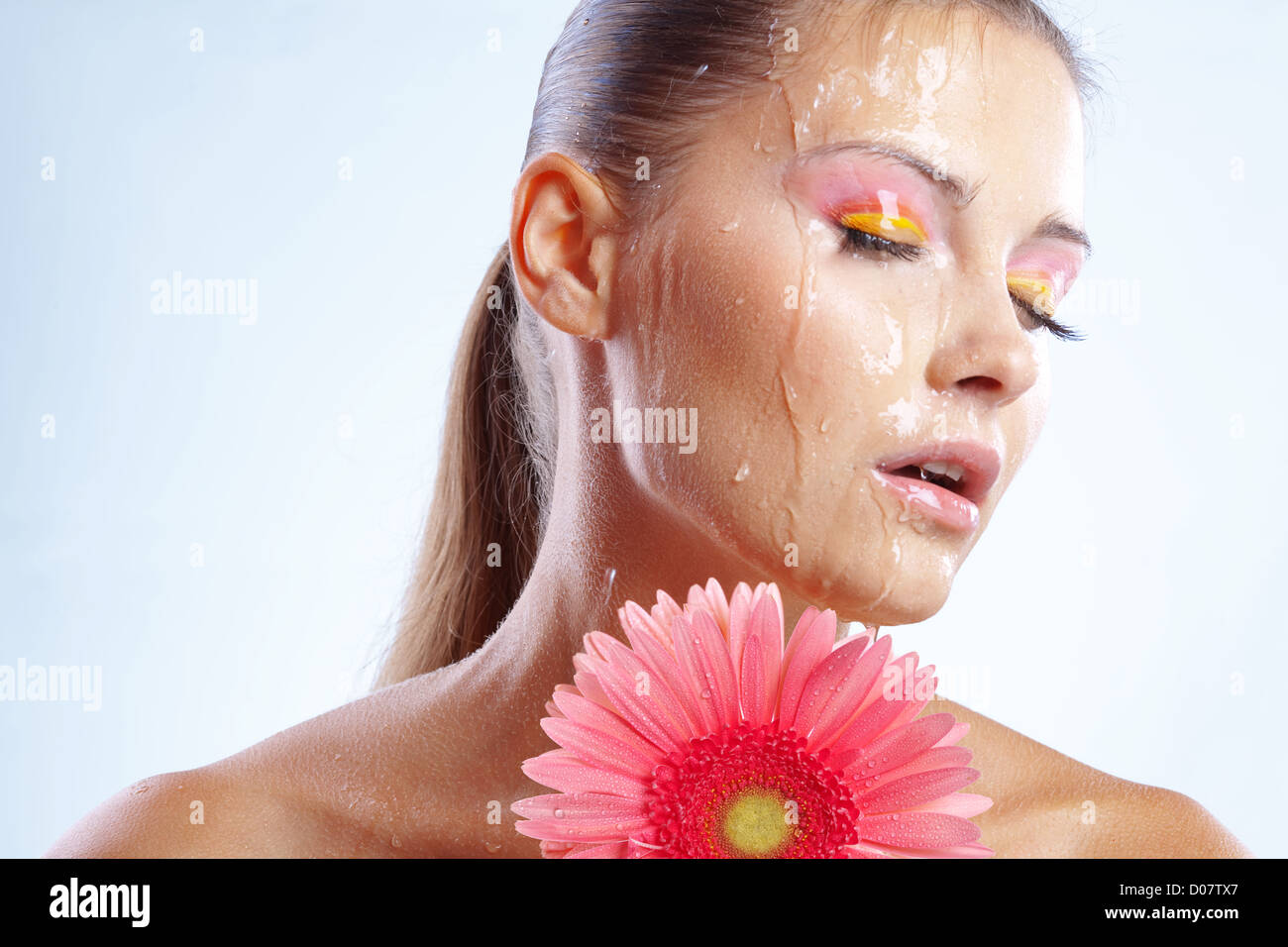 Portrait of beautiful female with flowing water on her face Stock Photo ...