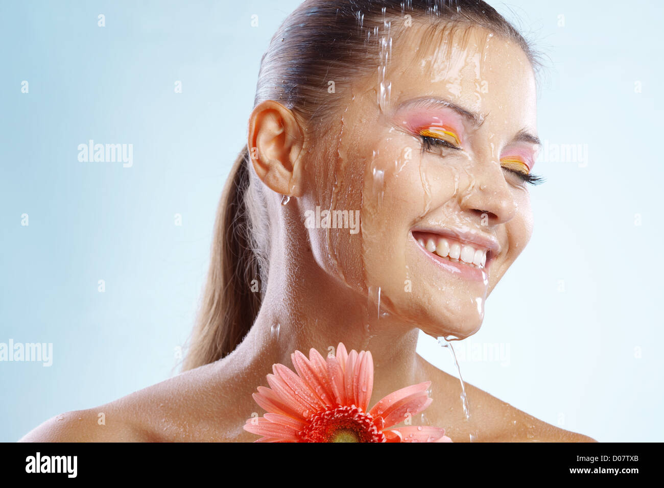 Portrait of beautiful female with flowing water on her face Stock Photo ...
