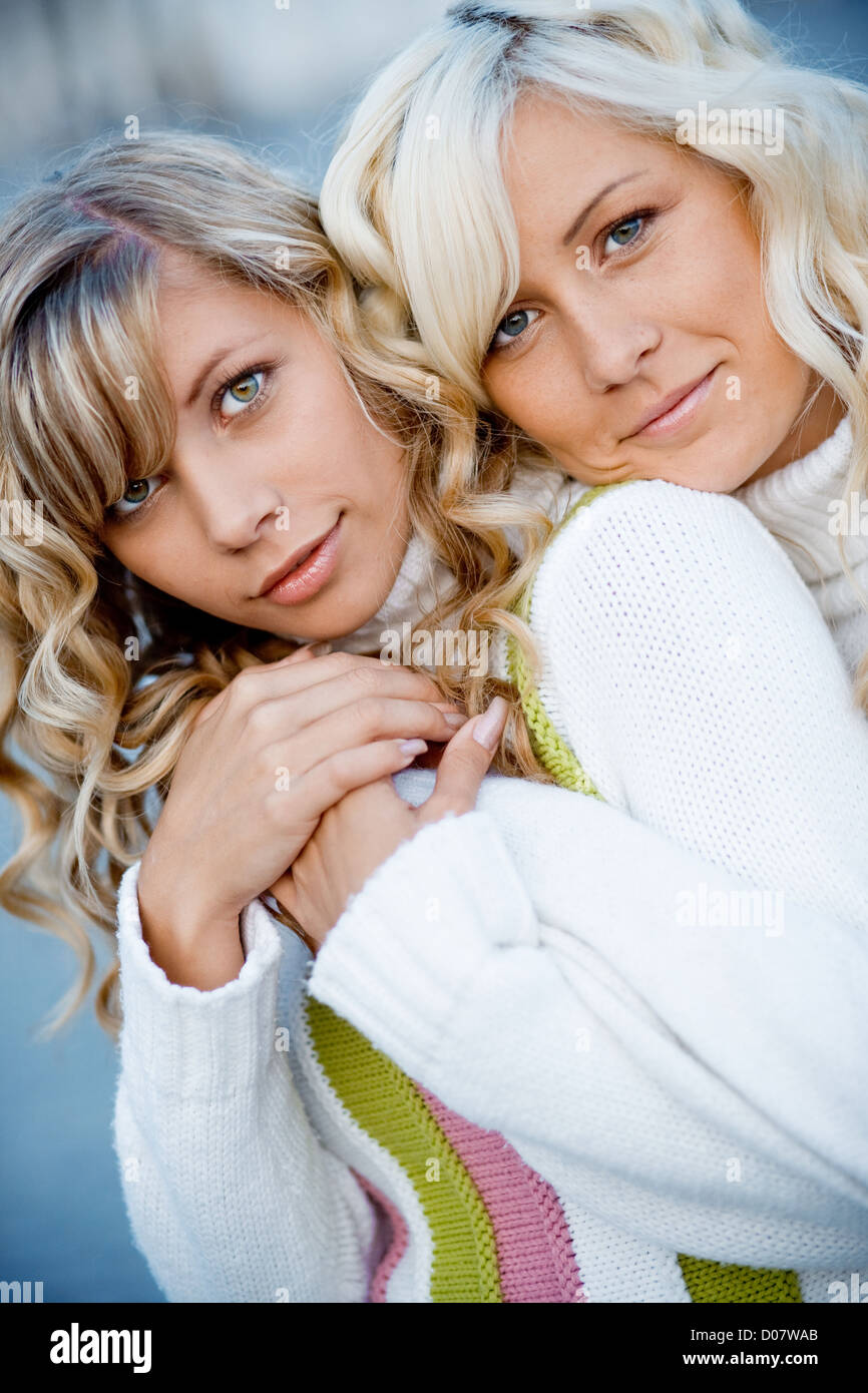 Family photo of sisters embracing outdoors closeup Stock Photo - Alamy