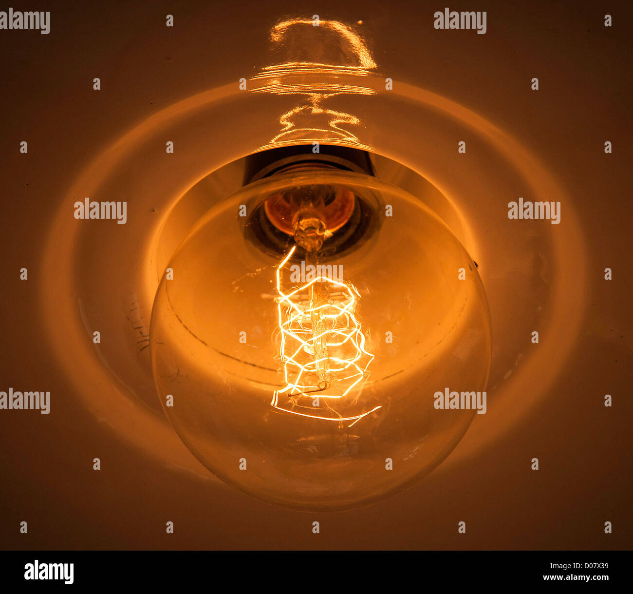 Glowing light bulb filament Stock Photo - Alamy