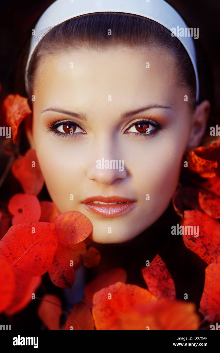 Close-up portrait of beautiful face in red autumn leaves Stock Photo ...