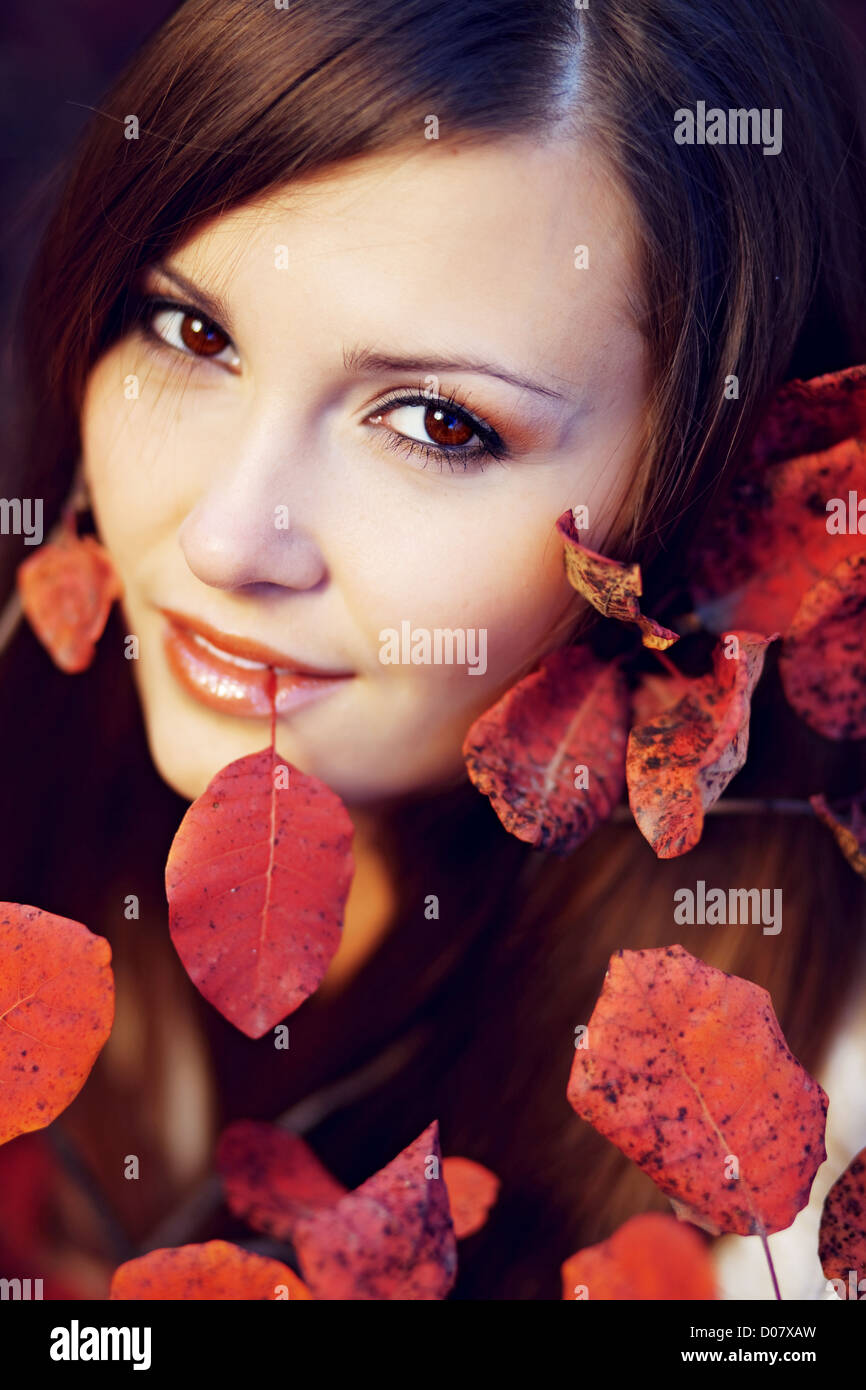 Close-up portrait of beautiful face in red autumn leaves Stock Photo ...