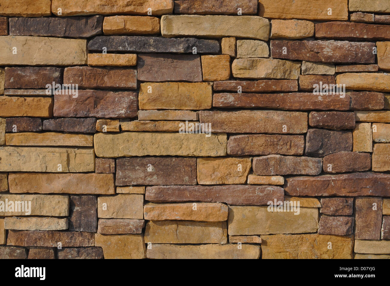 Wall of Multi Colored Stone used as a background Stock Photo - Alamy