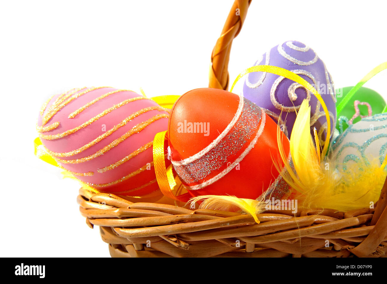 Cane basket with colorful easter eggs over white background Stock Photo ...