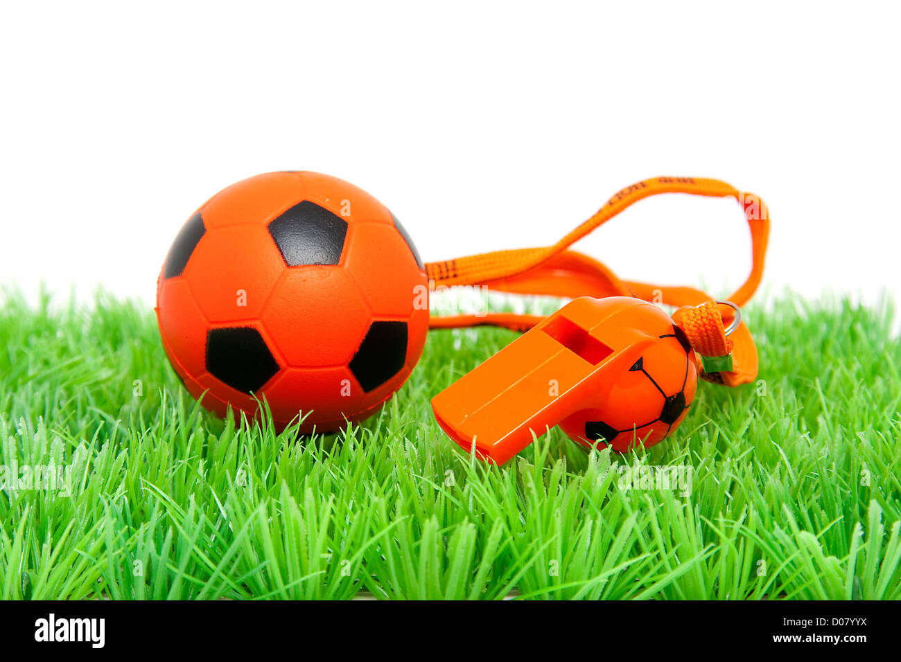 Orange soccer ball ans flute on grass over white background Stock Photo ...