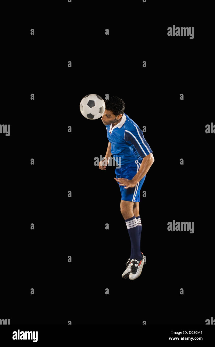 Man heading a soccer ball Stock Photo - Alamy