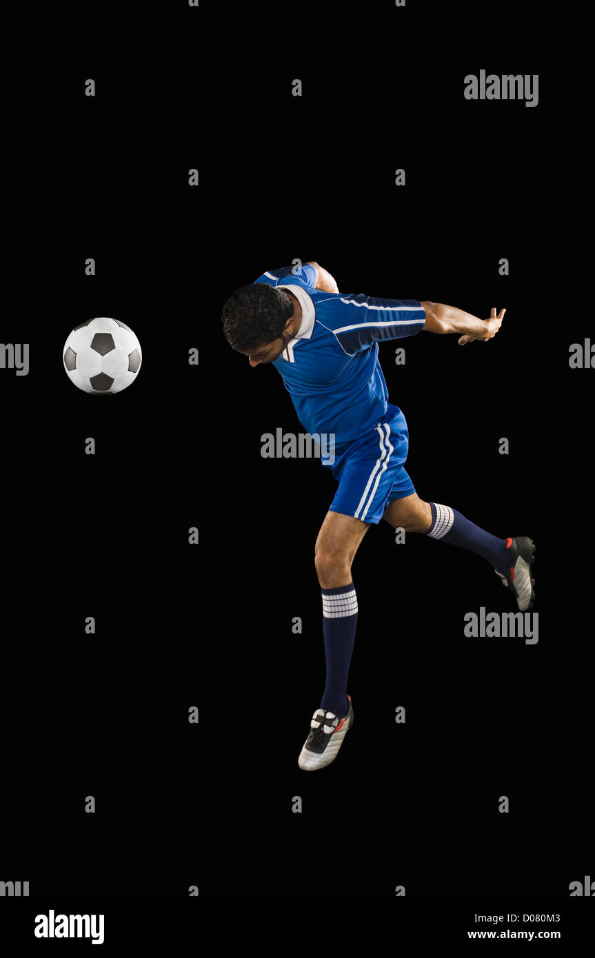 Man heading a soccer ball Stock Photo - Alamy
